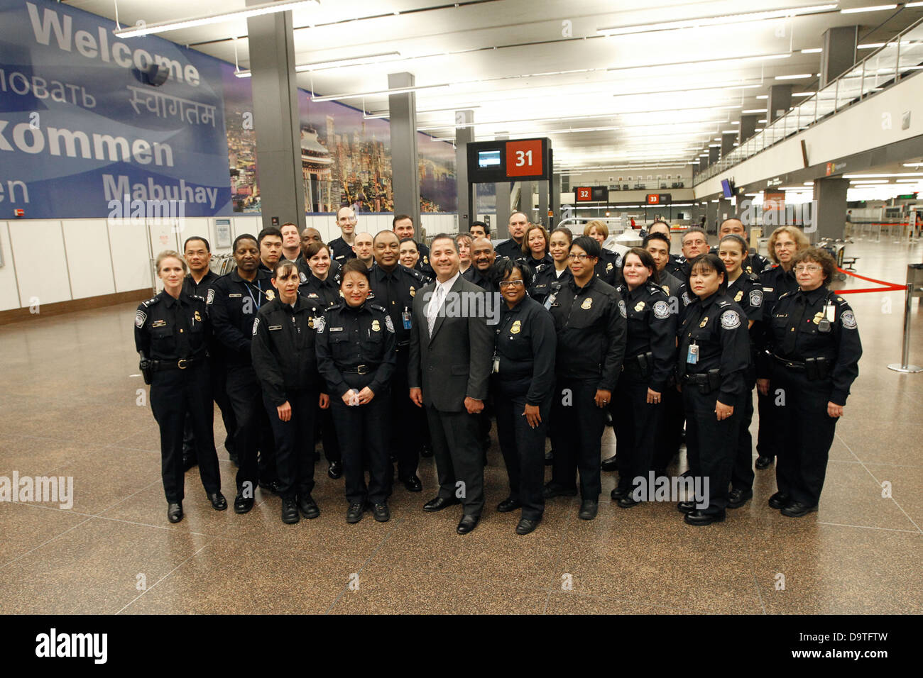 This image shows U.S. Customs and Border Protection officers monitoring ...