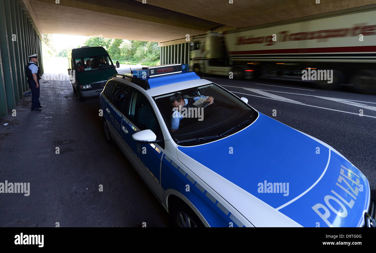 Police officers check a car at autobahn A7 near Flensburg, Germany, 07 ...