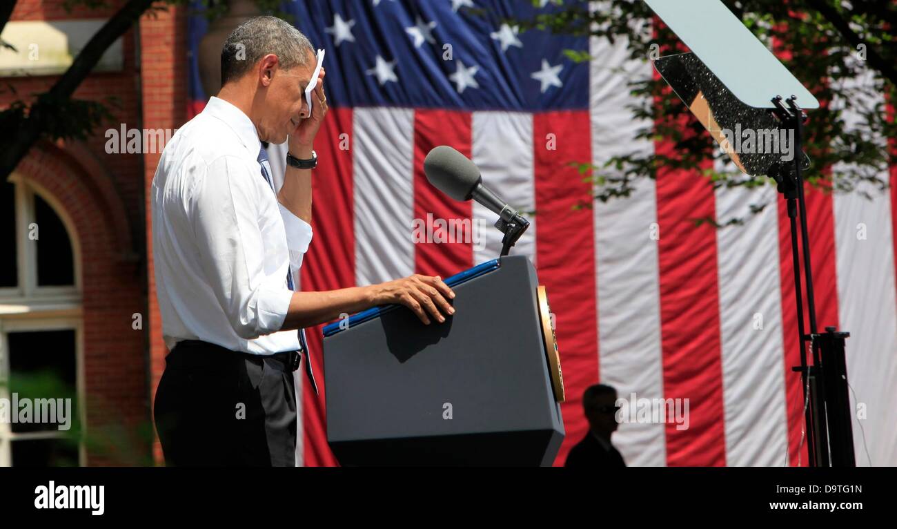 President Barack Obama wipes his face on a hot summer's day as he makes ...
