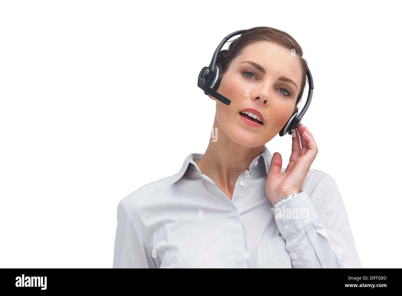 Businesswoman touching her headset Stock Photo - Alamy