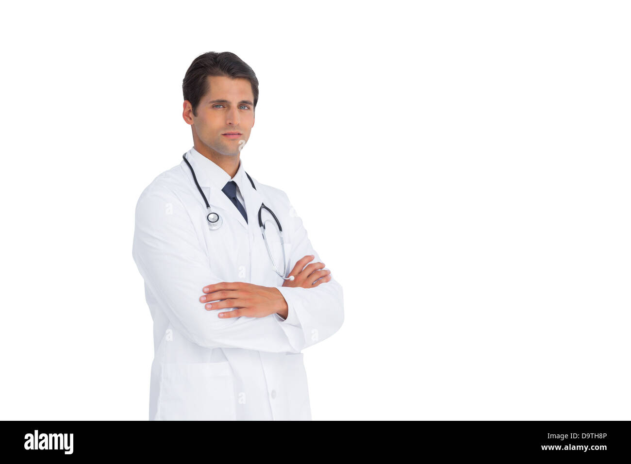 Handsome doctor standing with arms crossed Stock Photo - Alamy