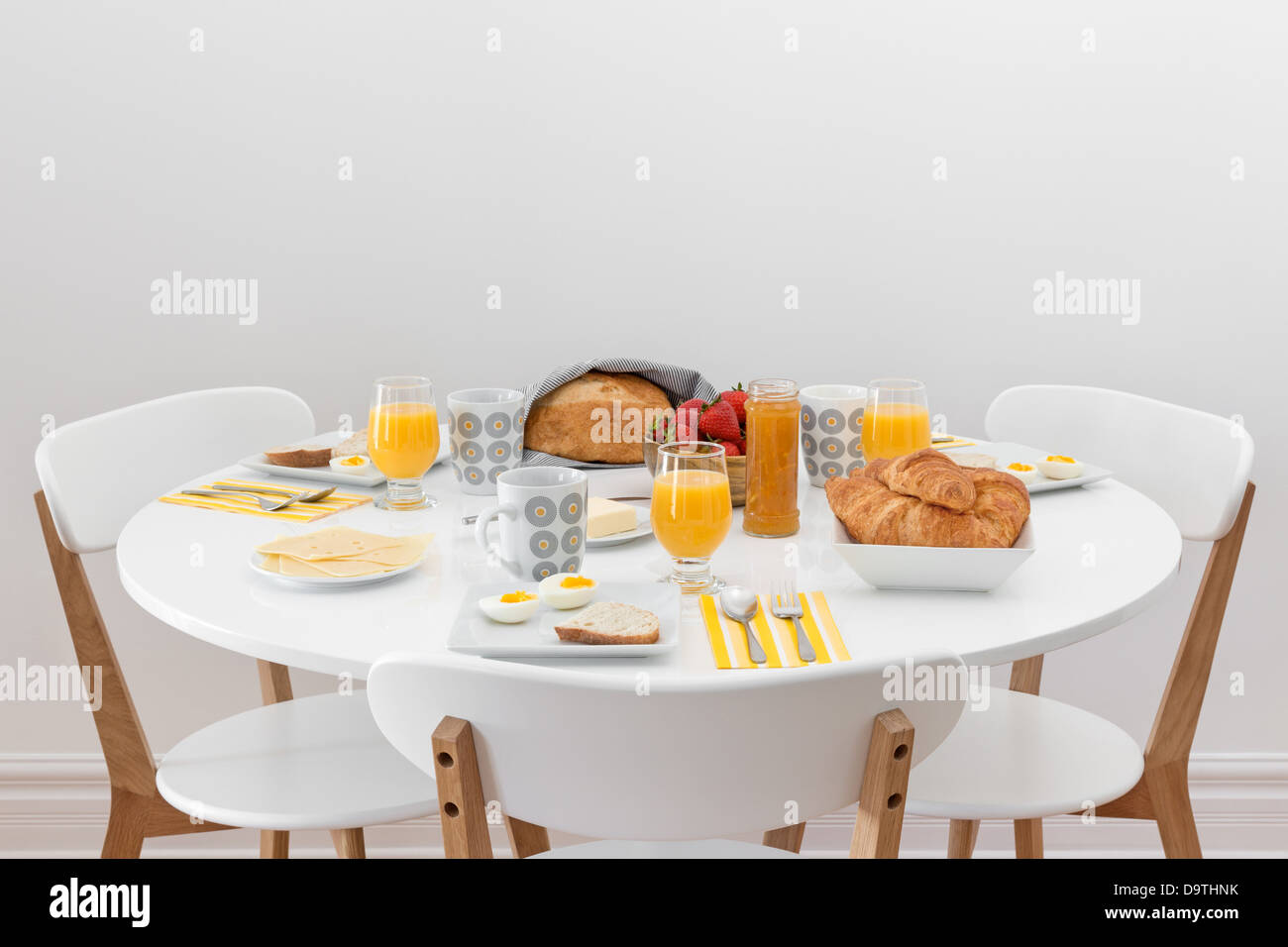 Breakfast for three. Simple tasty morning meal on a white table Stock ...