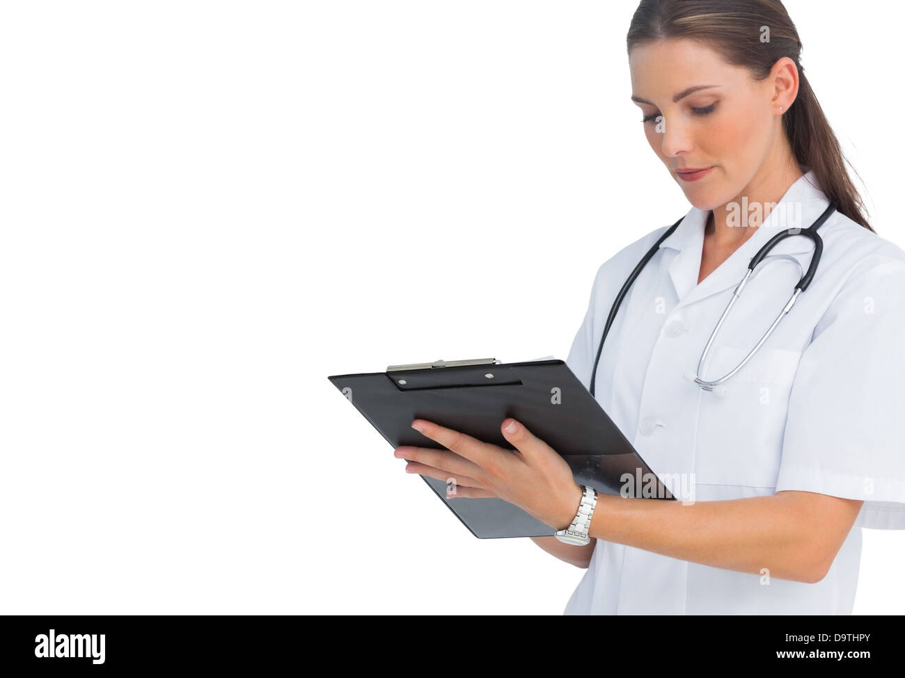 Serious nurse writing on clipboard Stock Photo - Alamy