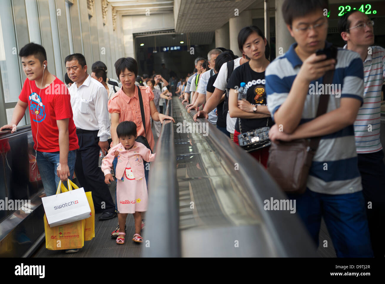 Passengers take the elevator at a subway station in Beijing, China ...