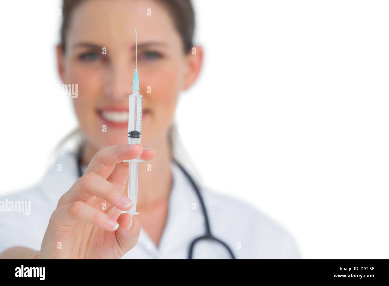 Happy nurse holding a syringe up Stock Photo - Alamy