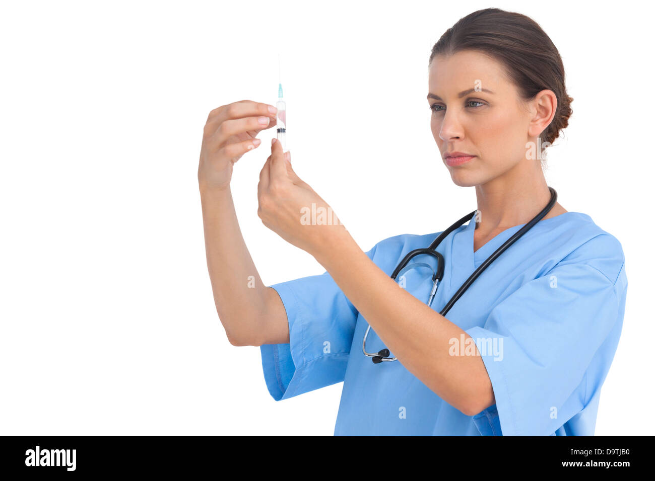 Serious surgeon holding up needle and checking it Stock Photo - Alamy