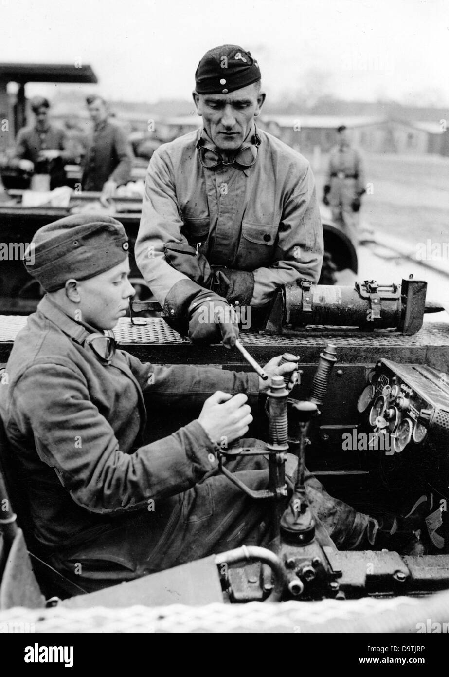 A Hitler boy is receiving a short training course as tank driver at a ...