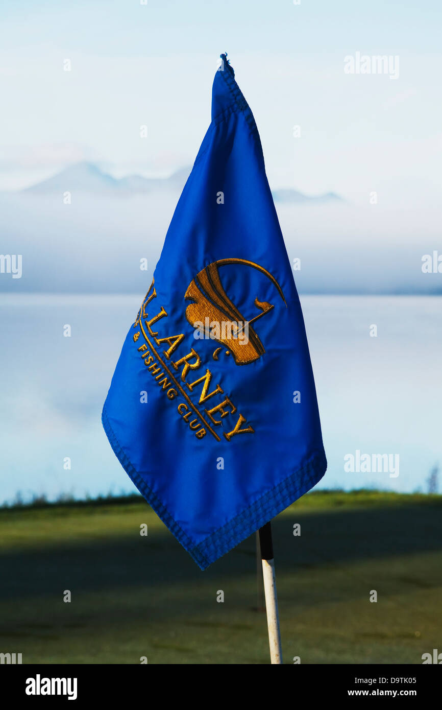 A blue flag on a golf course at the water's edge;Killarney county kerry ...
