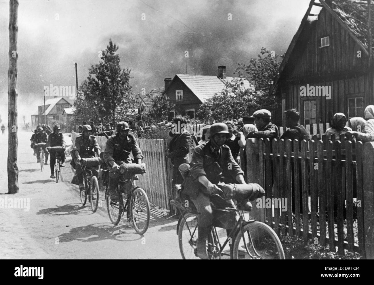 Soldiers of the bicycle troops ride their bikes through a village on ...