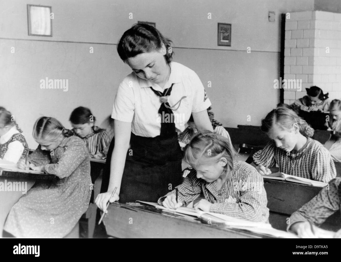 A girl of the German Girls League (BDM) teaches children at a school in ...