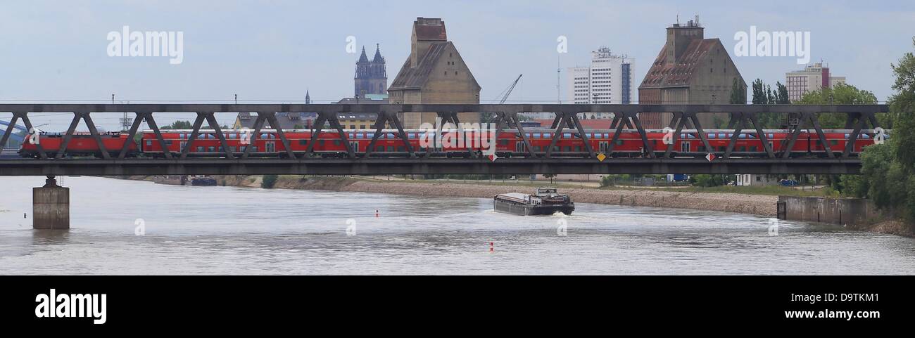 A Deutsche Bahn passenger train crosses the Elbe River in Magdeburg ...