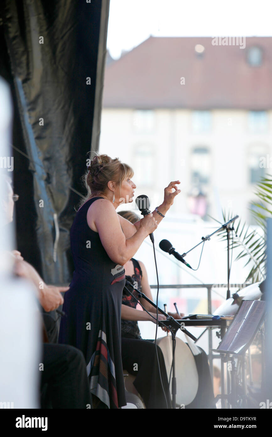 Music band and female singer performing on stage during traditional ...