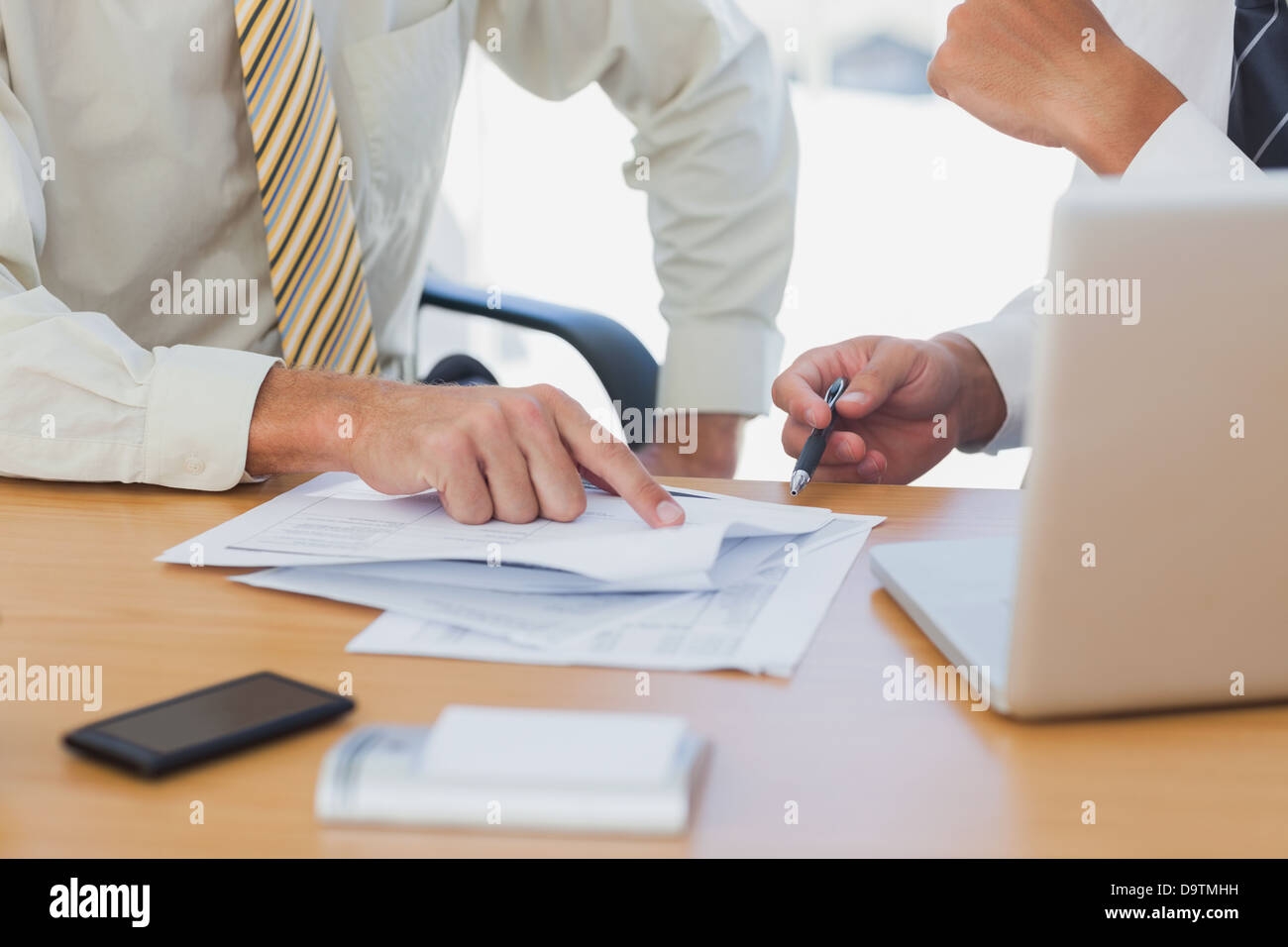 Businessmen going over paperwork Stock Photo - Alamy