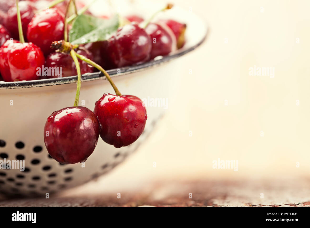 Macro photography fresh cherries in colander Stock Photo - Alamy