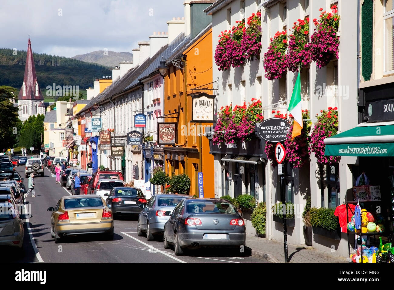 Cars and colourful buildings along henry street;Kenmare county kerry ...