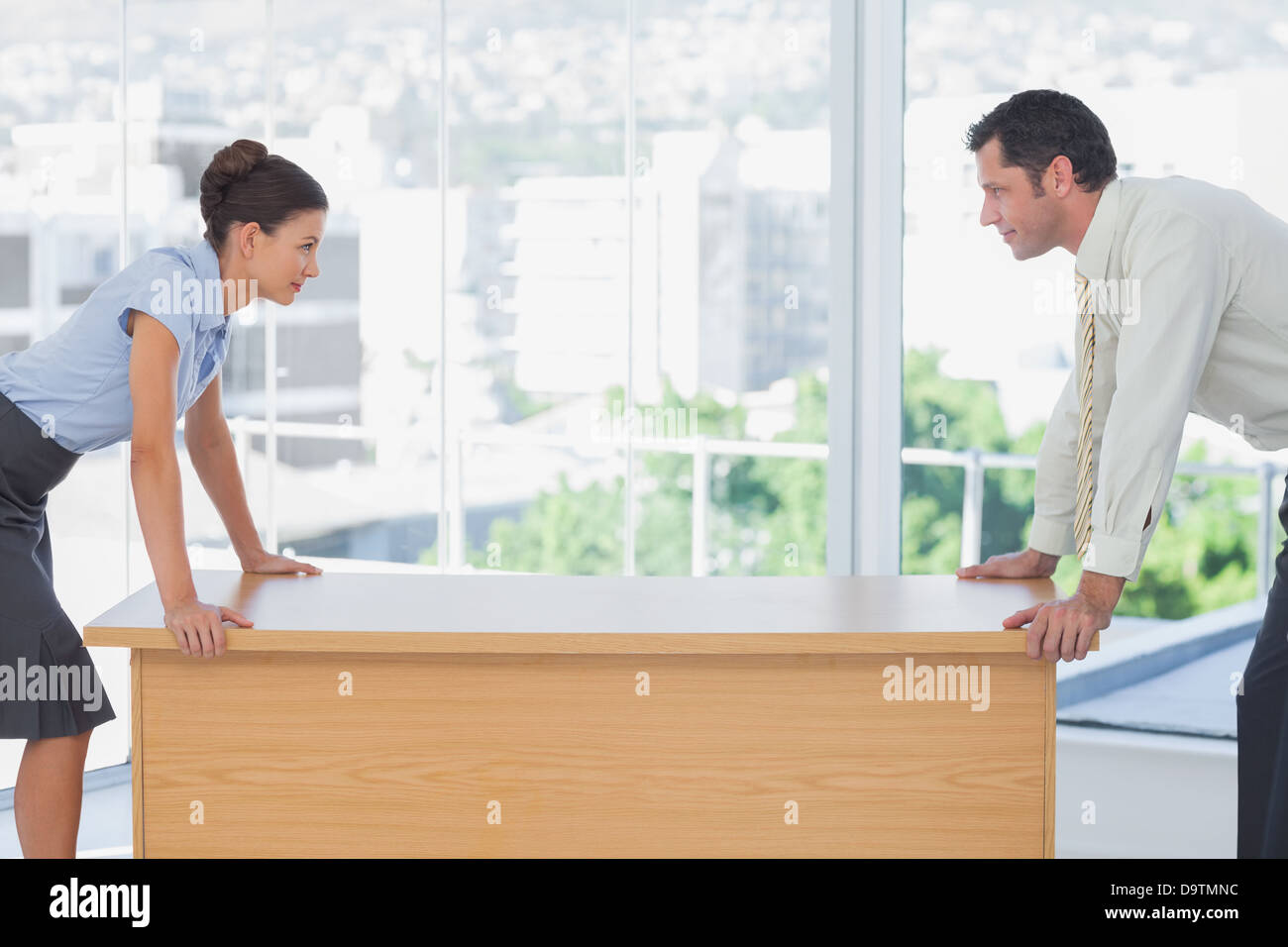 Business people facing off at desk Stock Photo - Alamy