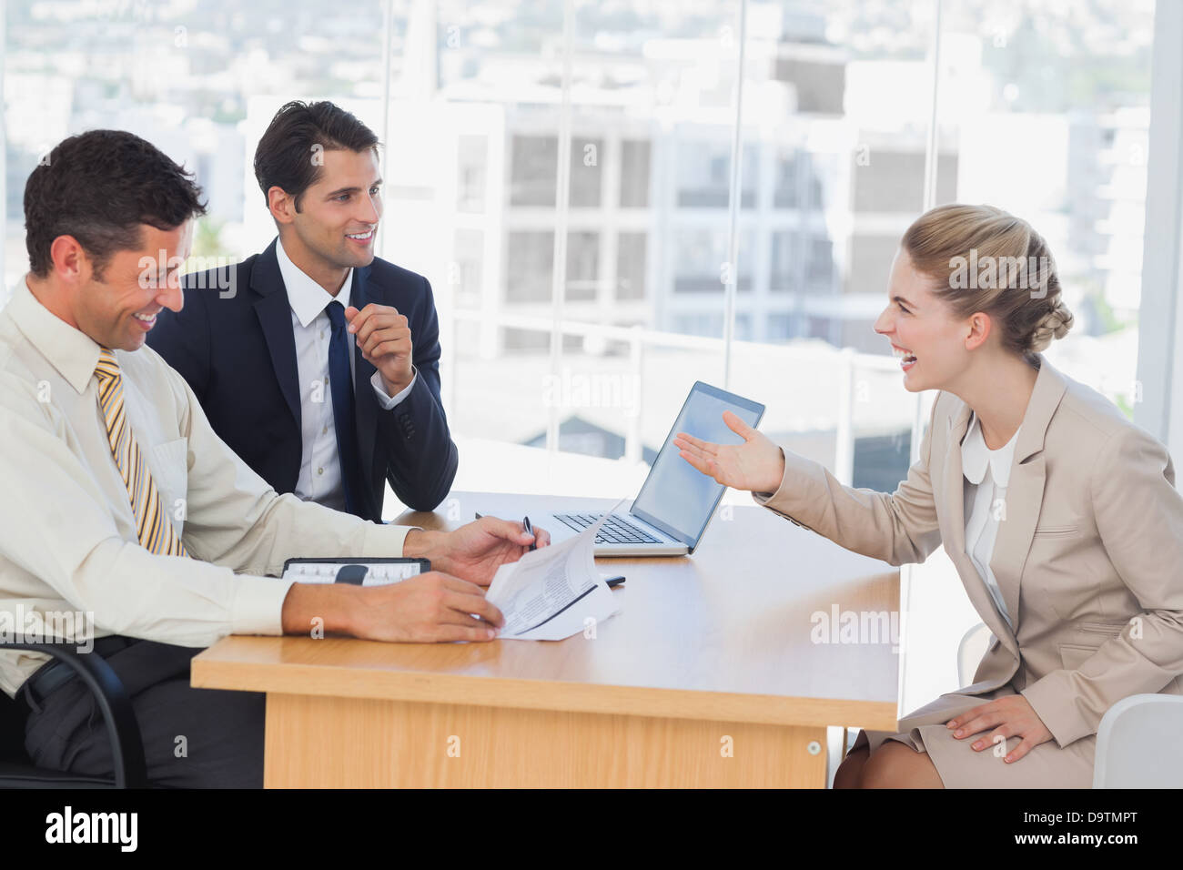 Business people laughing with interviewee Stock Photo - Alamy