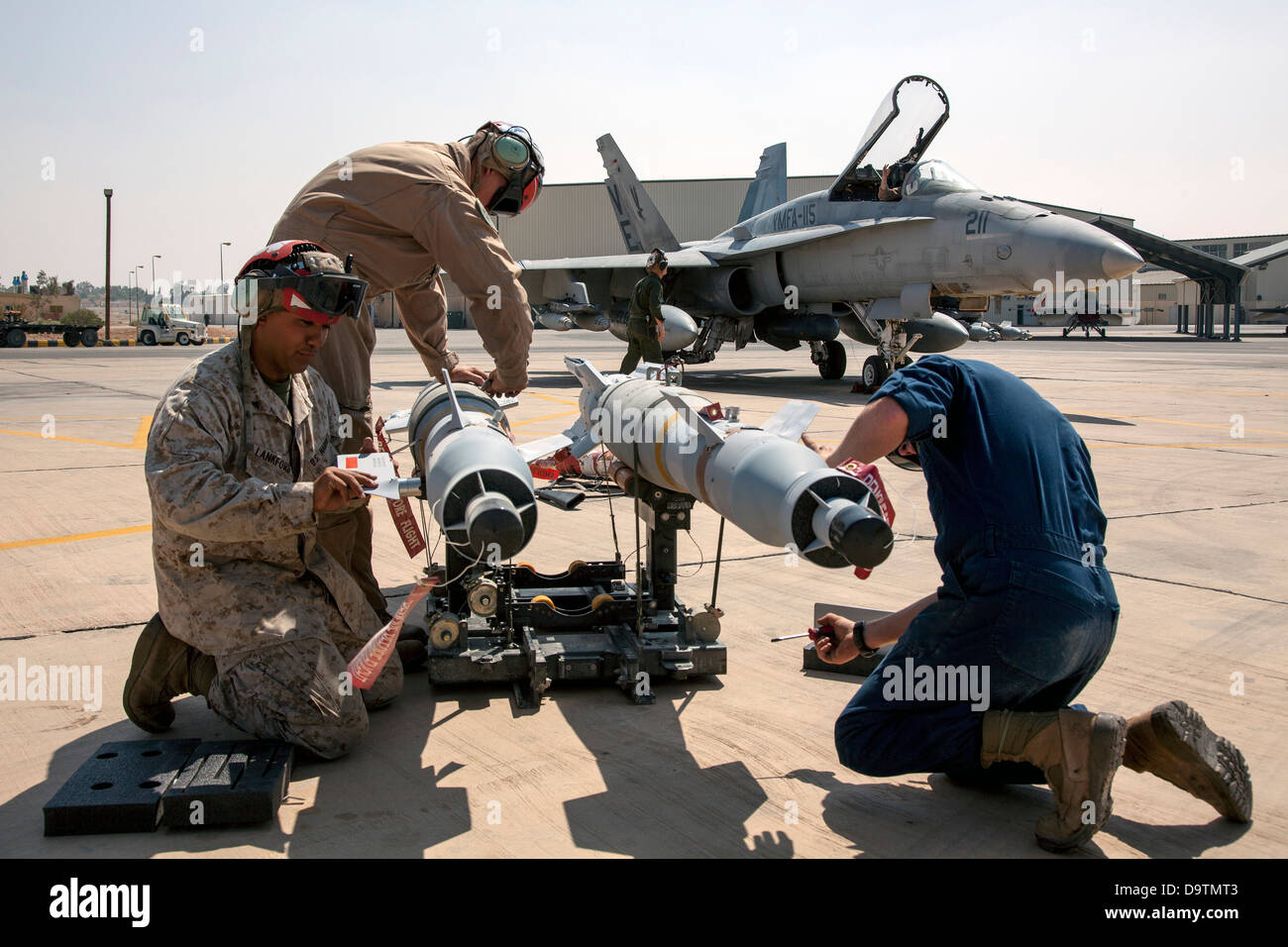 Marines from the VMFA-115 squadron attach fins on Joint Direct Attack ...