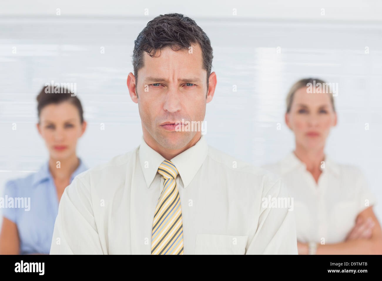 Boss standing in front of business team Stock Photo - Alamy