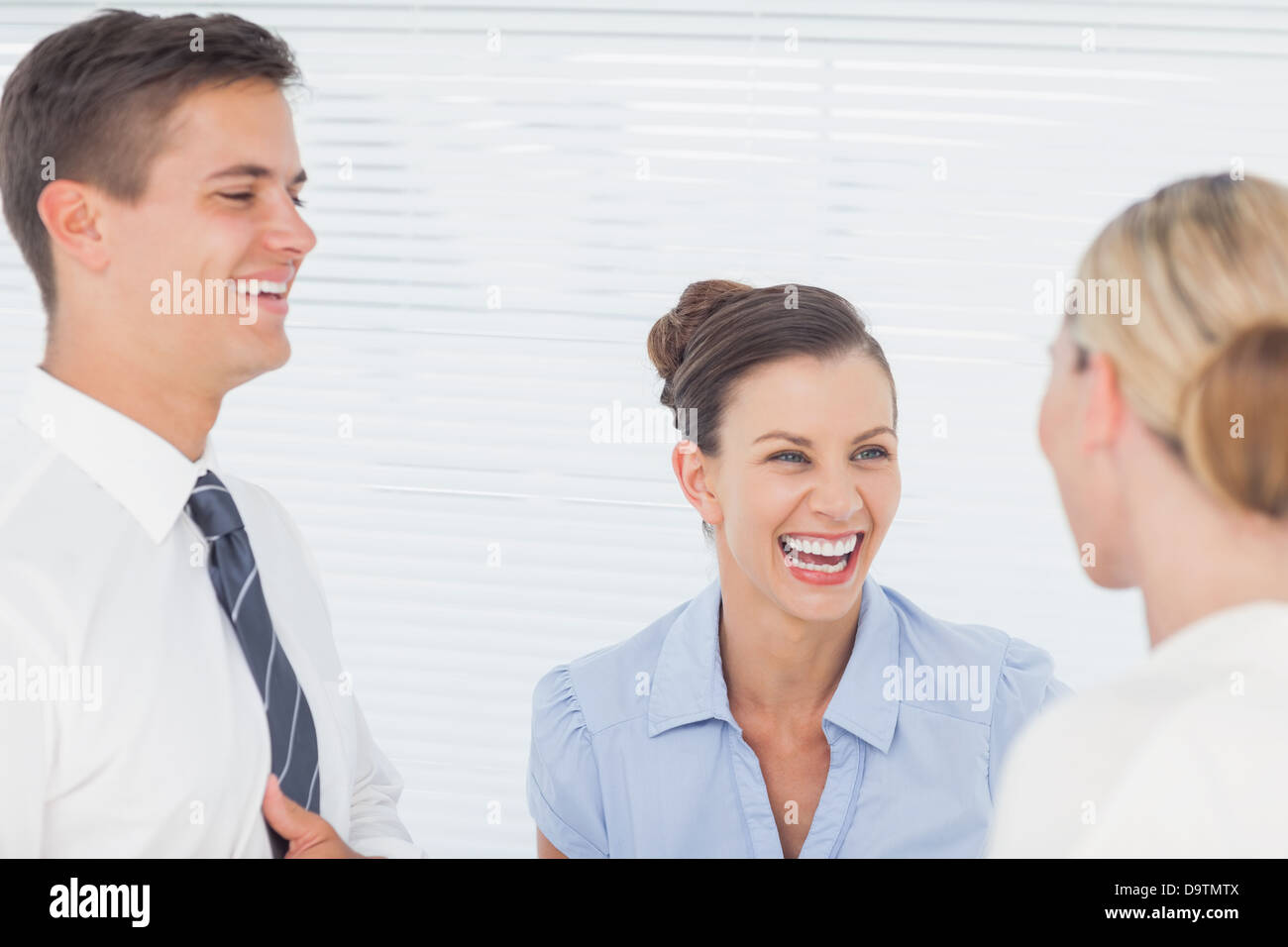 Happy business people laughing together Stock Photo - Alamy