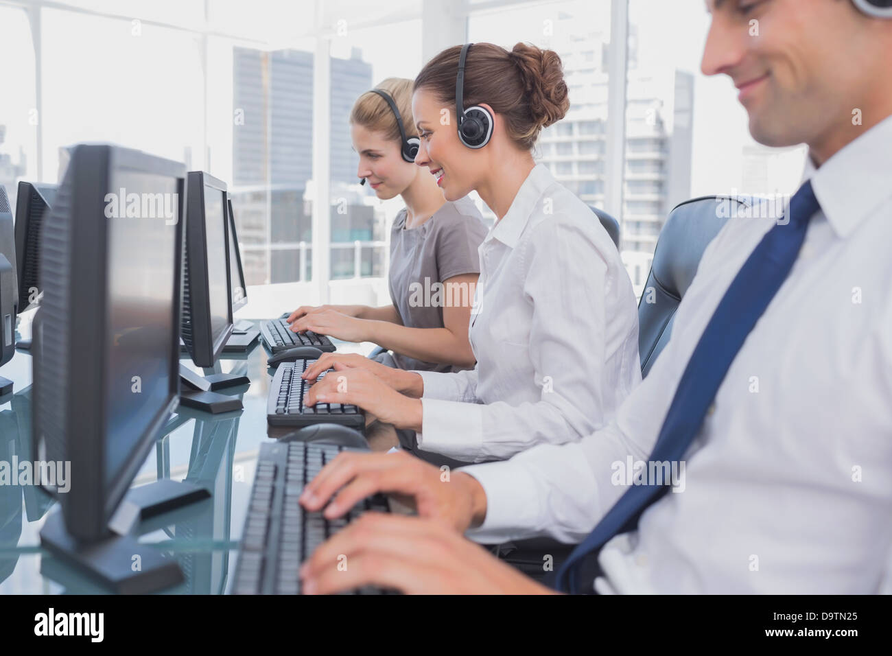 Smiling female employees work hi-res stock photography and images - Alamy