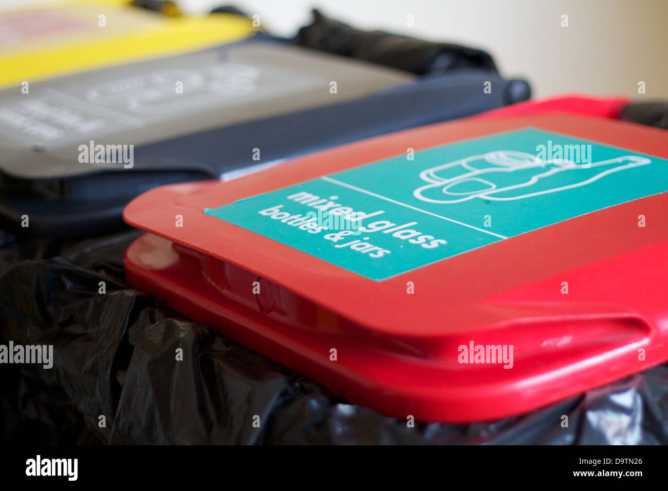 A line of recycling bins in different colours Stock Photo - Alamy