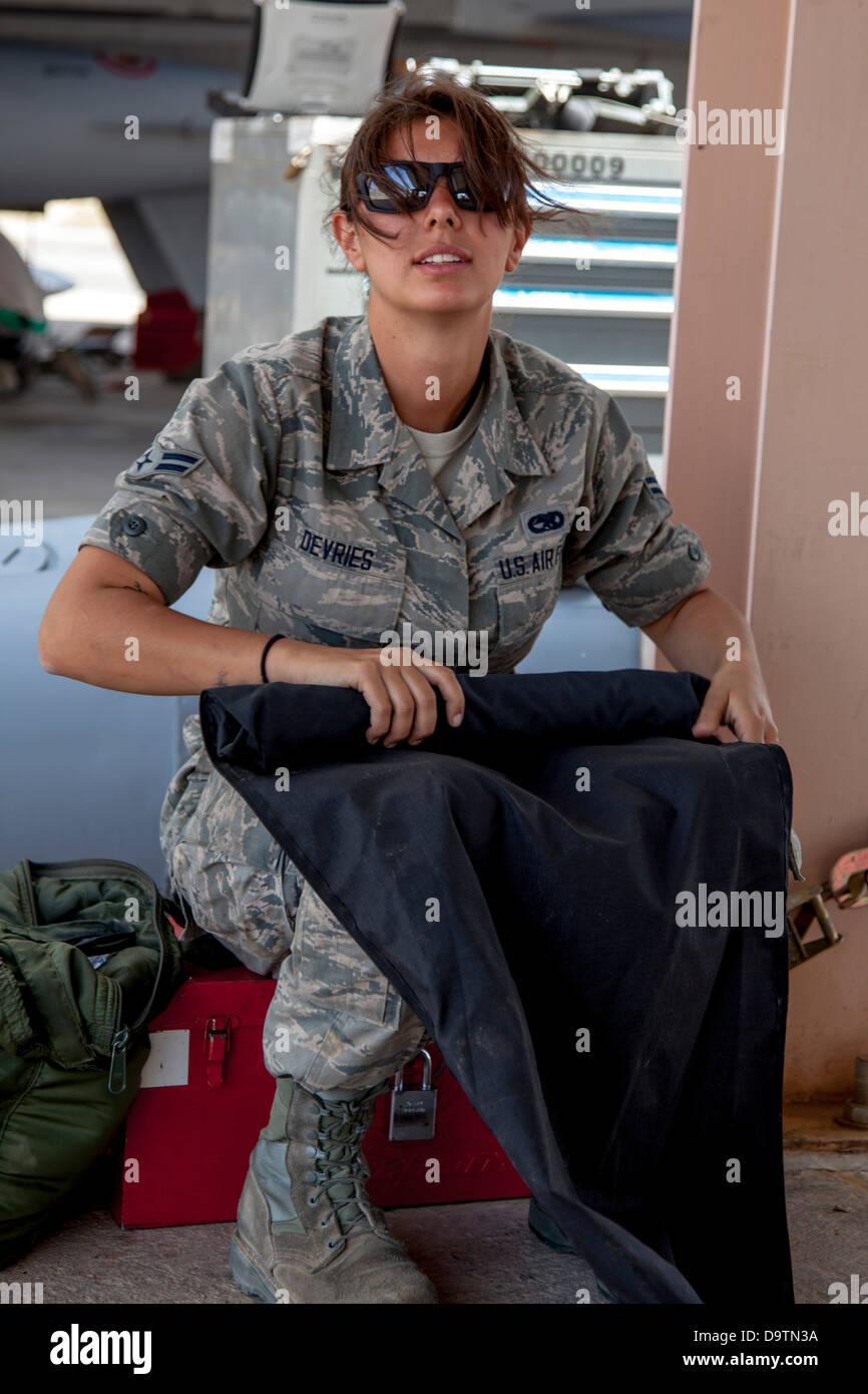 Airman First Class Jami DeVries wraps up a seat cover during ...