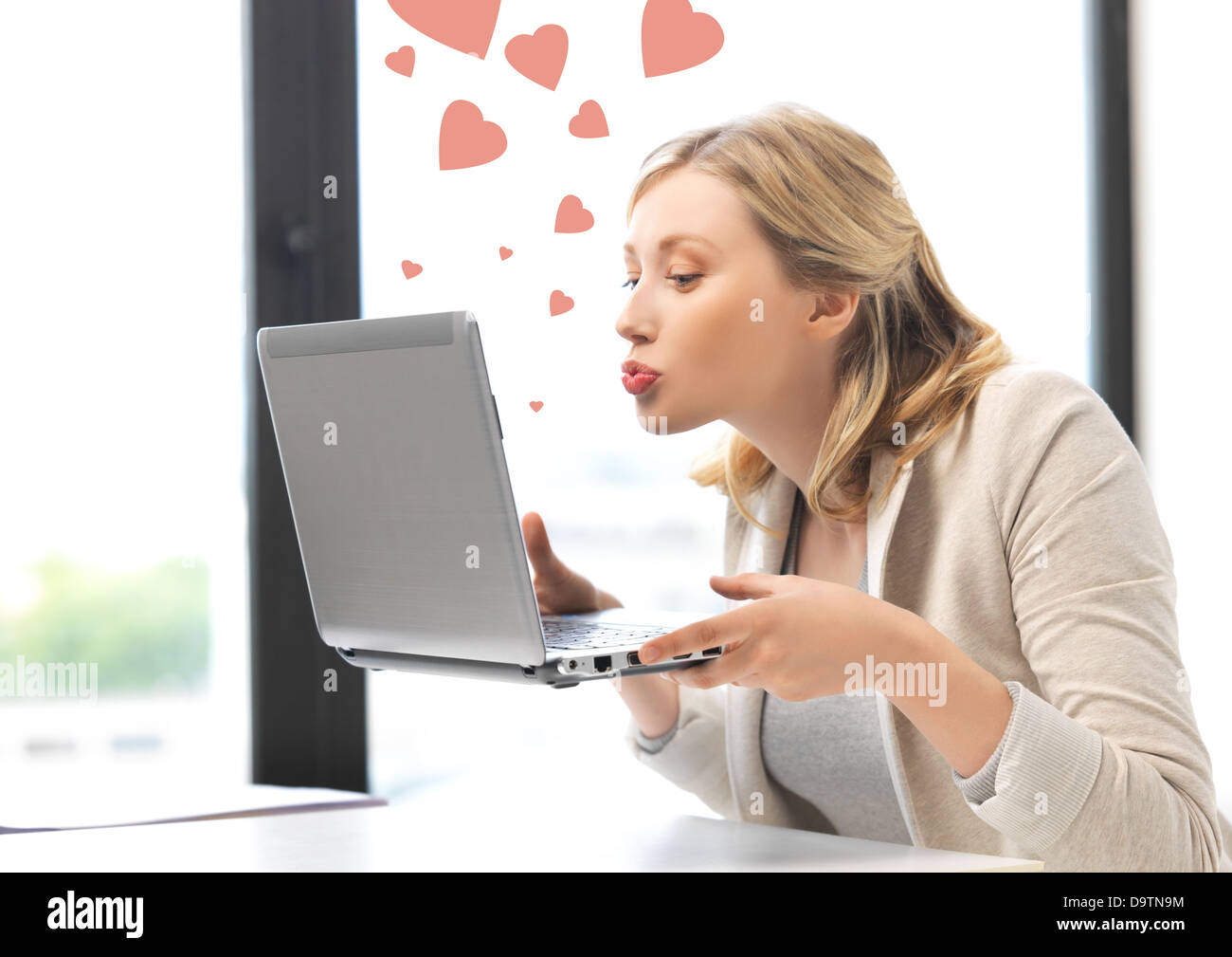 woman with computer kissing the screen Stock Photo - Alamy