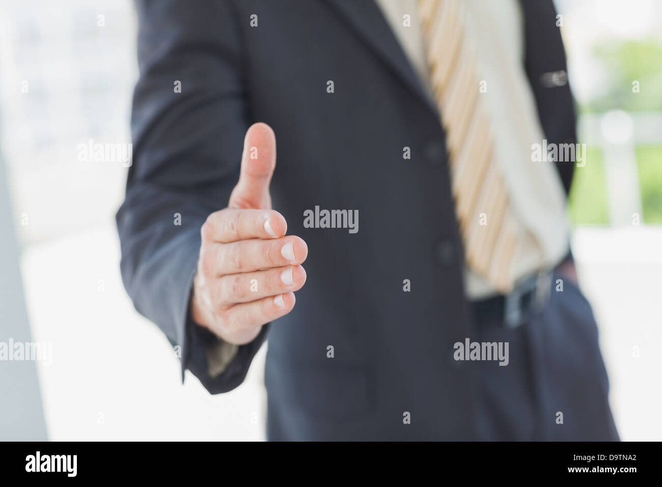 Businessman extending hand for handshake Stock Photo - Alamy