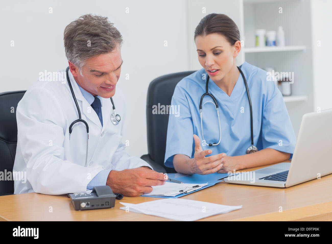 Two doctors working on an important folder Stock Photo - Alamy