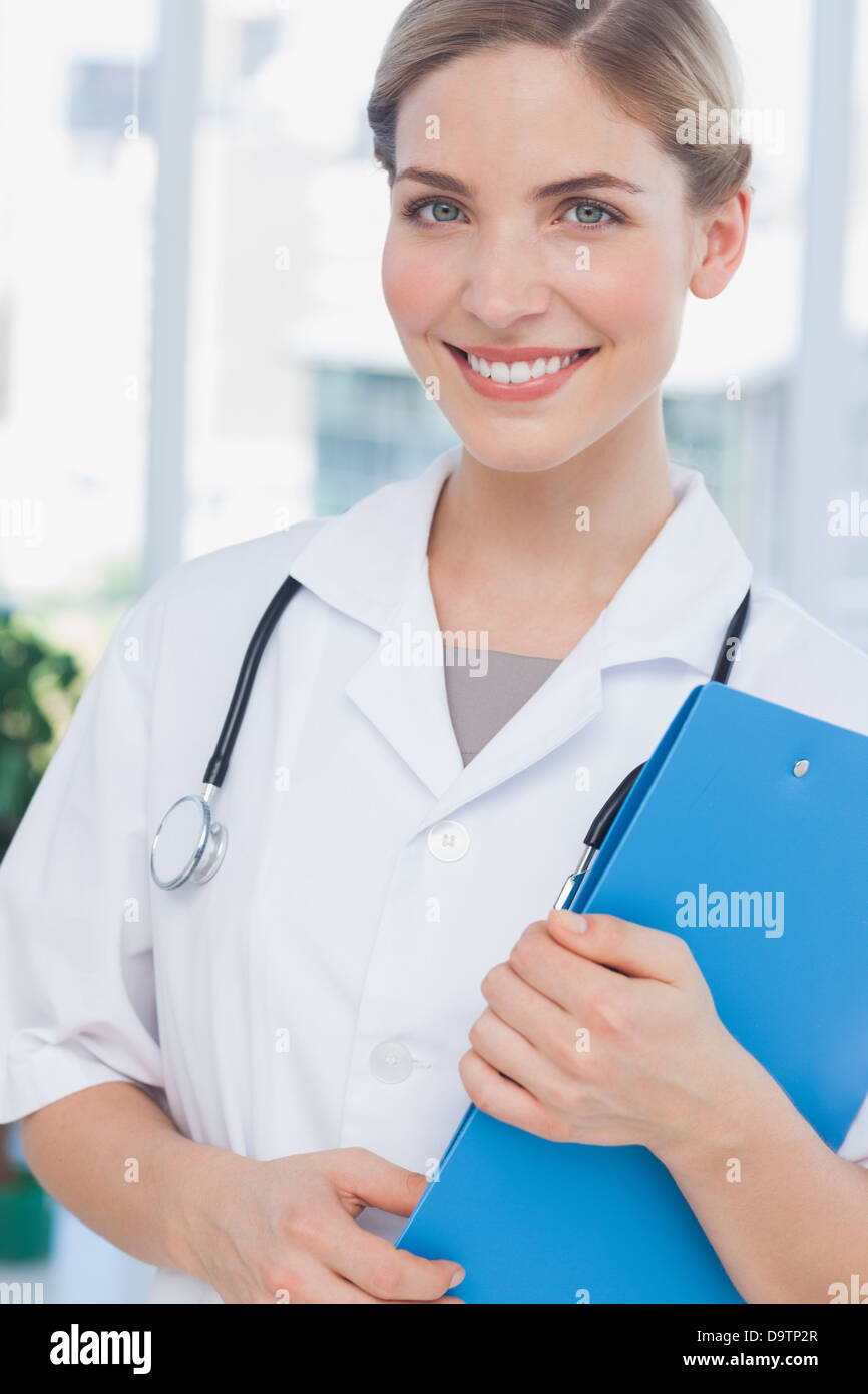 Radiant nurse holding a folder Stock Photo - Alamy