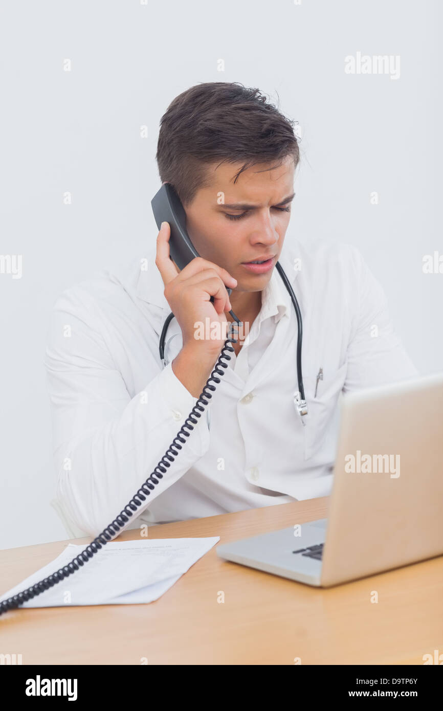 Young doctor calling Stock Photo - Alamy