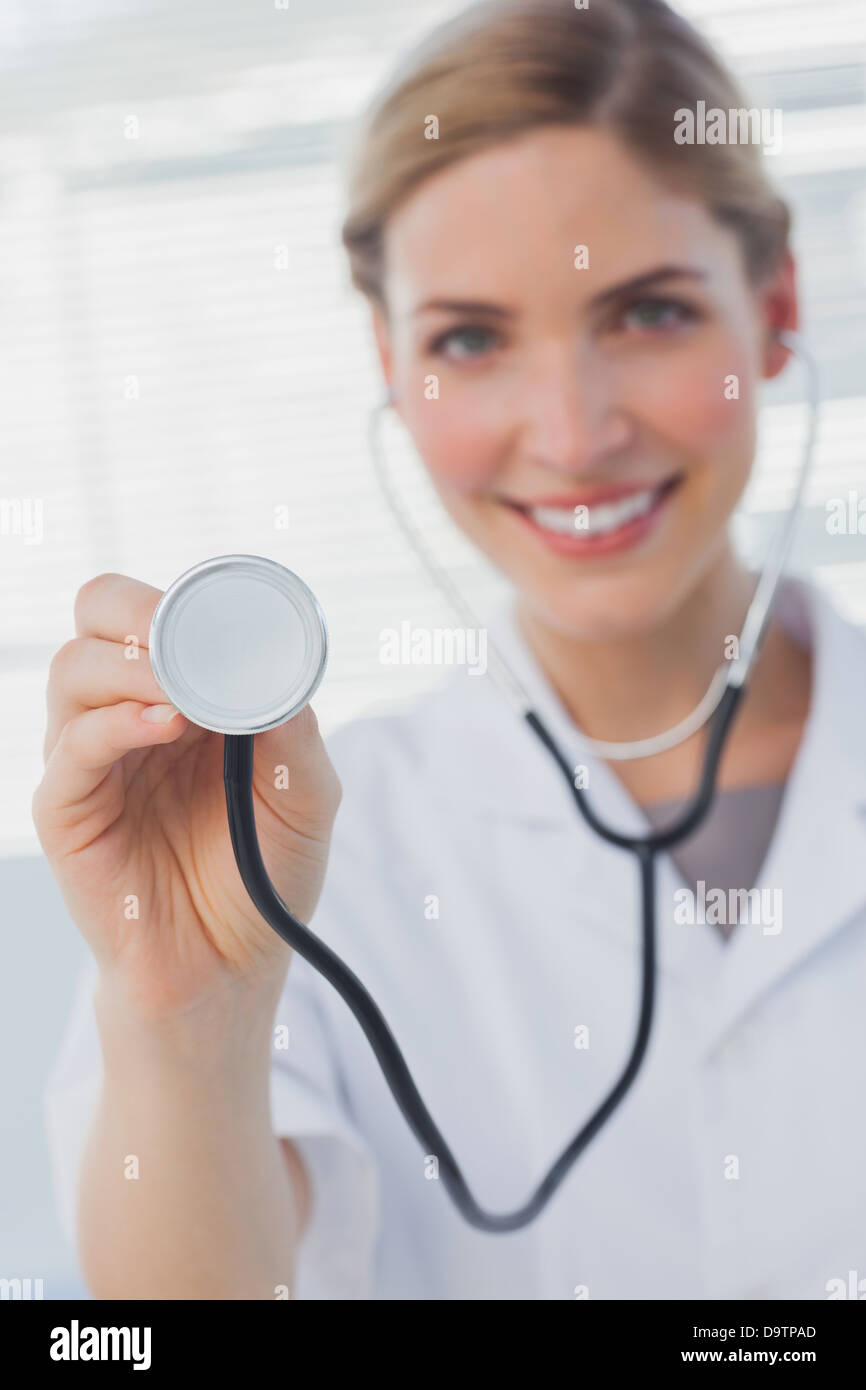 Smiling nurse showing her stethoscope Stock Photo - Alamy