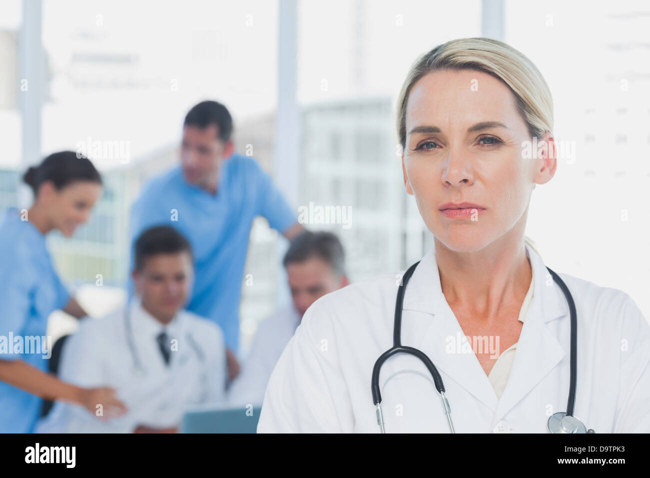 Serious doctor standing Stock Photo - Alamy