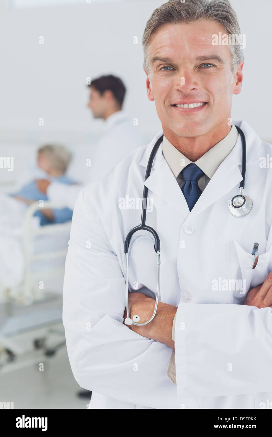 Attractive doctor with arms crossed Stock Photo - Alamy