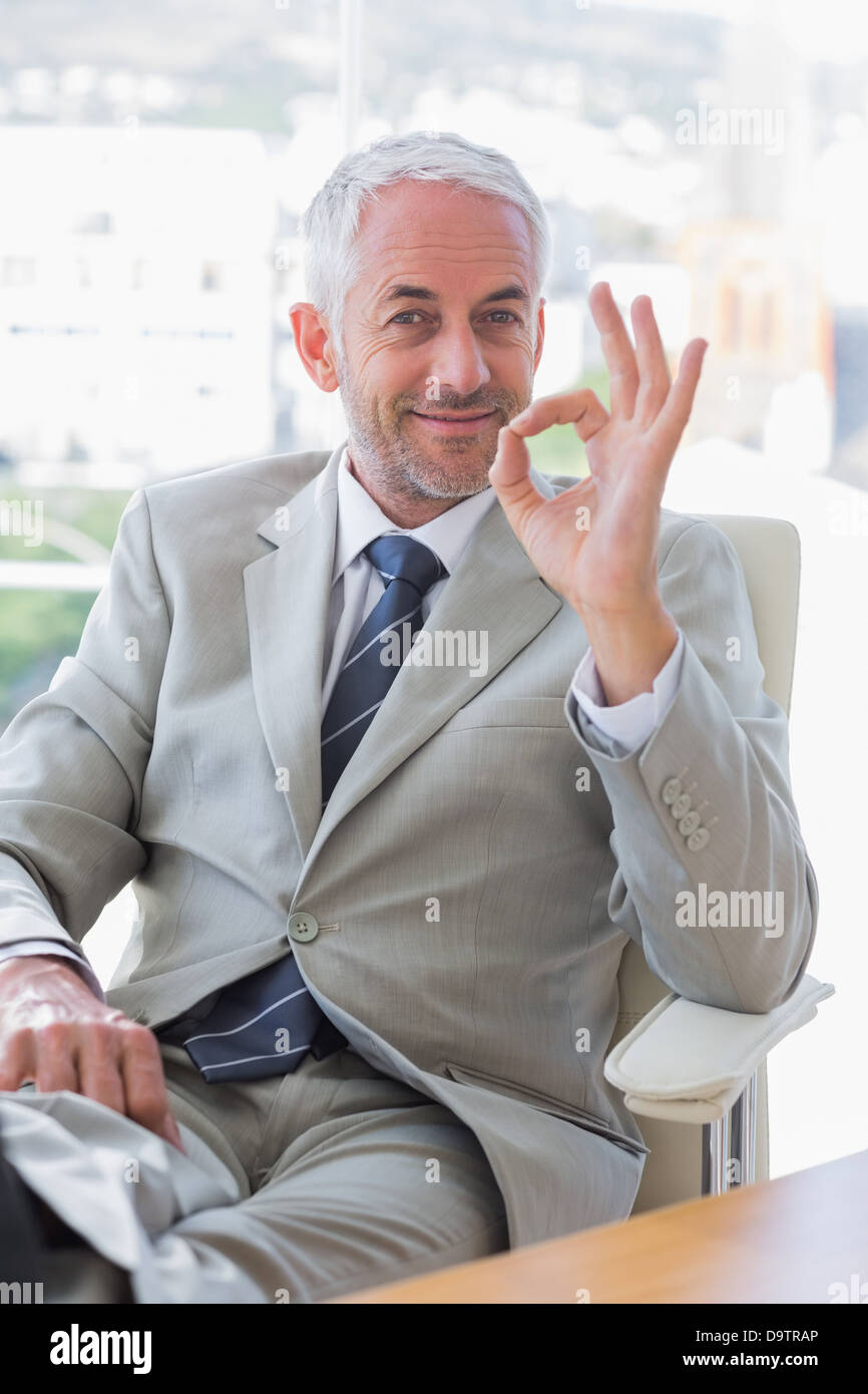 Happy businessman giving ok sign Stock Photo - Alamy