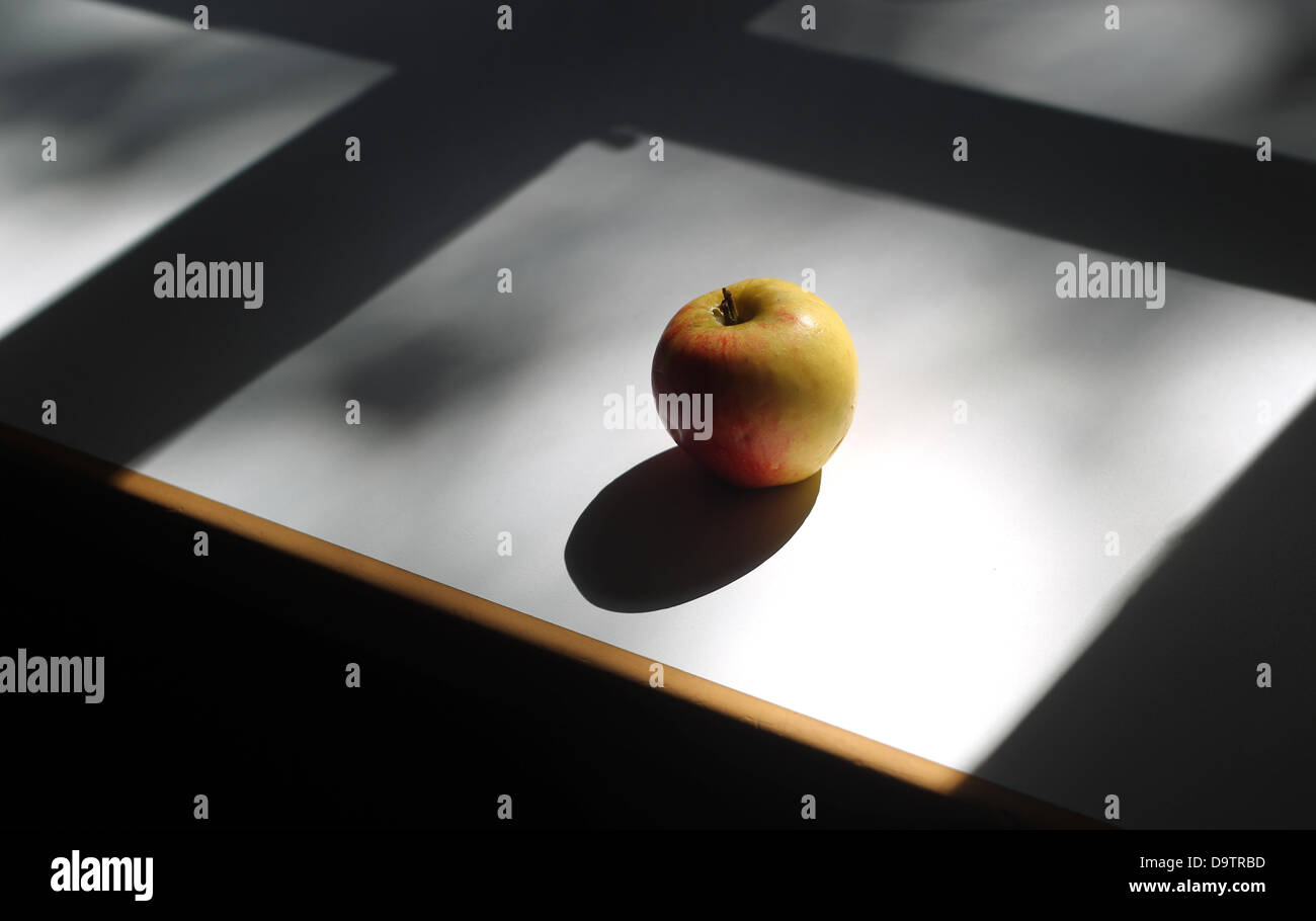 An apple lies in between the shadow of a window frame in Kaufbeuren ...