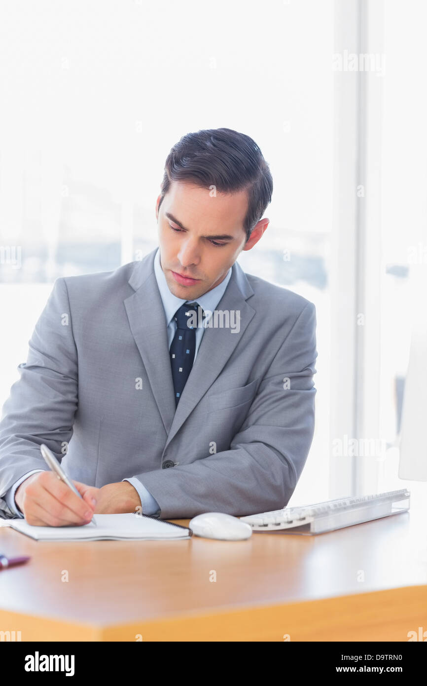Handsome focused businessman writing hi-res stock photography and ...