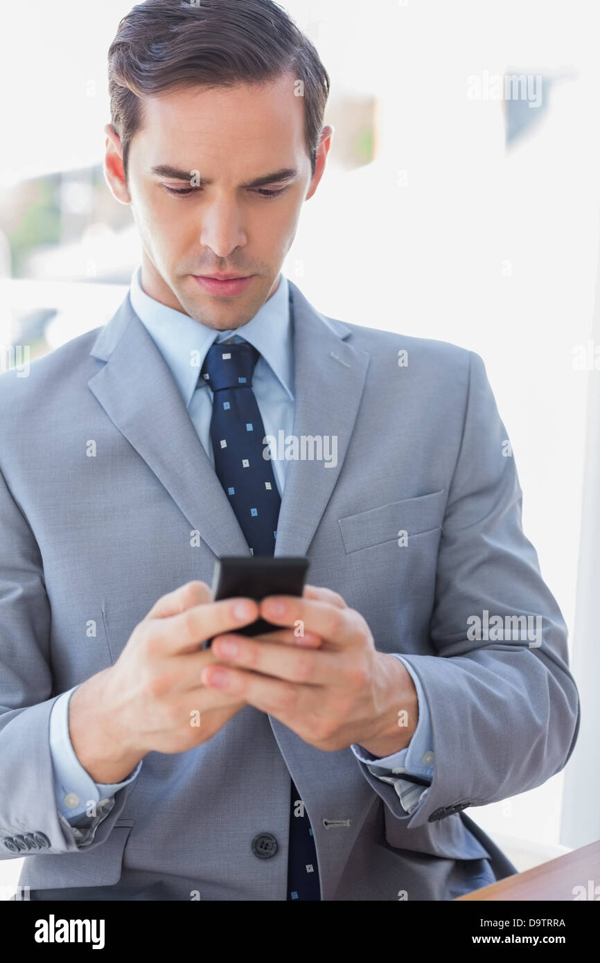 Businessman texting on smartphone sitting hi-res stock photography and ...