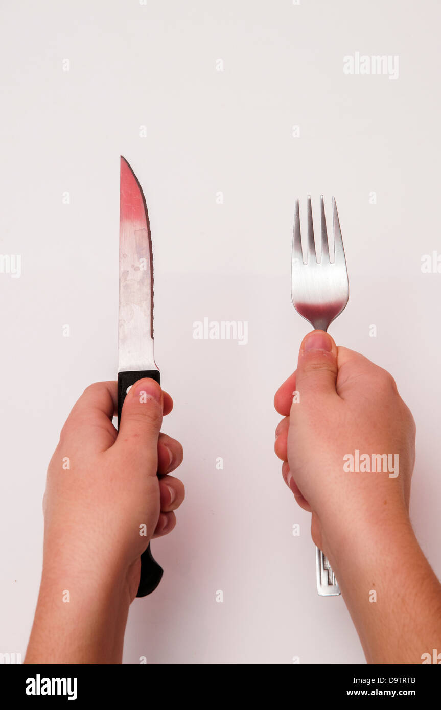 hand with fork and knife on a white background Stock Photo - Alamy
