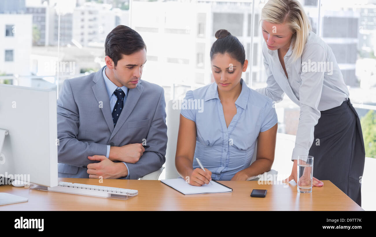 Business team working with a notepad Stock Photo - Alamy