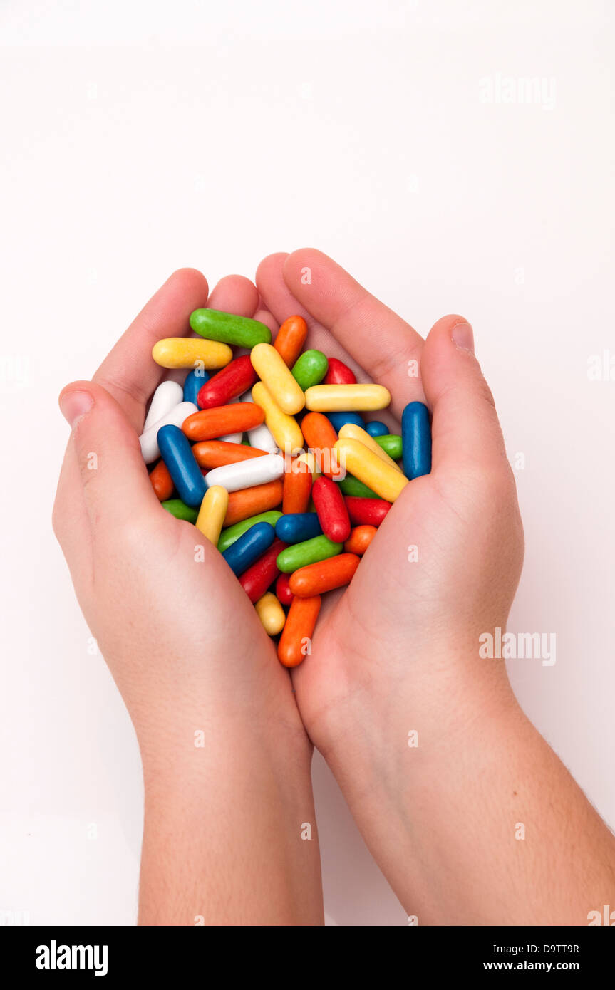 hand full of candy on a white background Stock Photo - Alamy