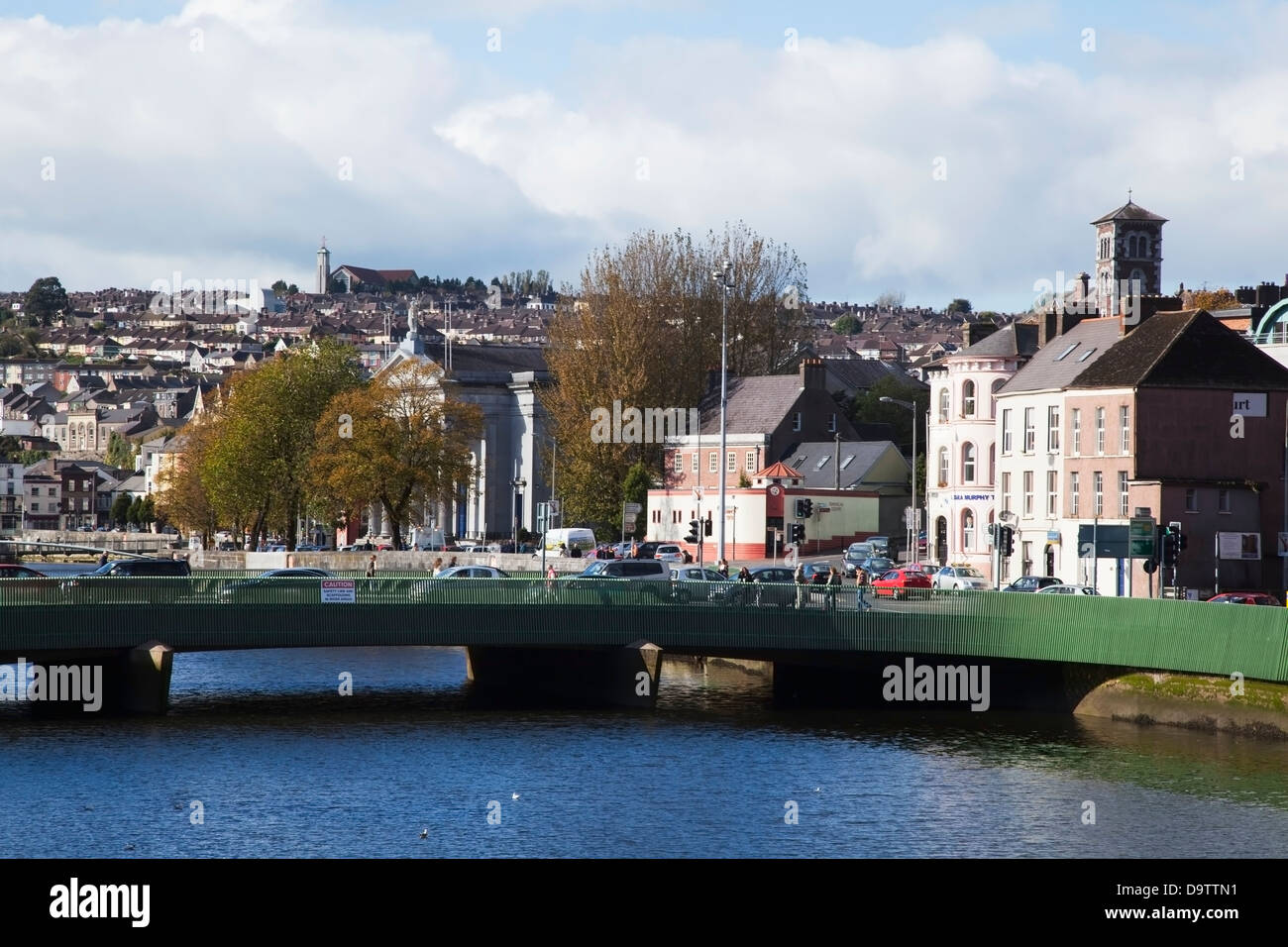 Pedestrians and cars on a bridge crossing the river lee;Cork city ...