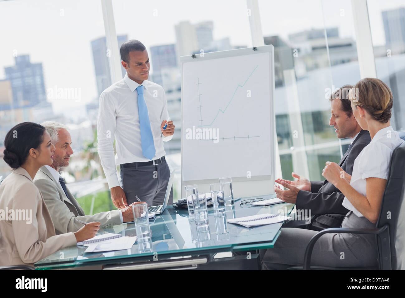 Manager standing in front of colleagues Stock Photo - Alamy