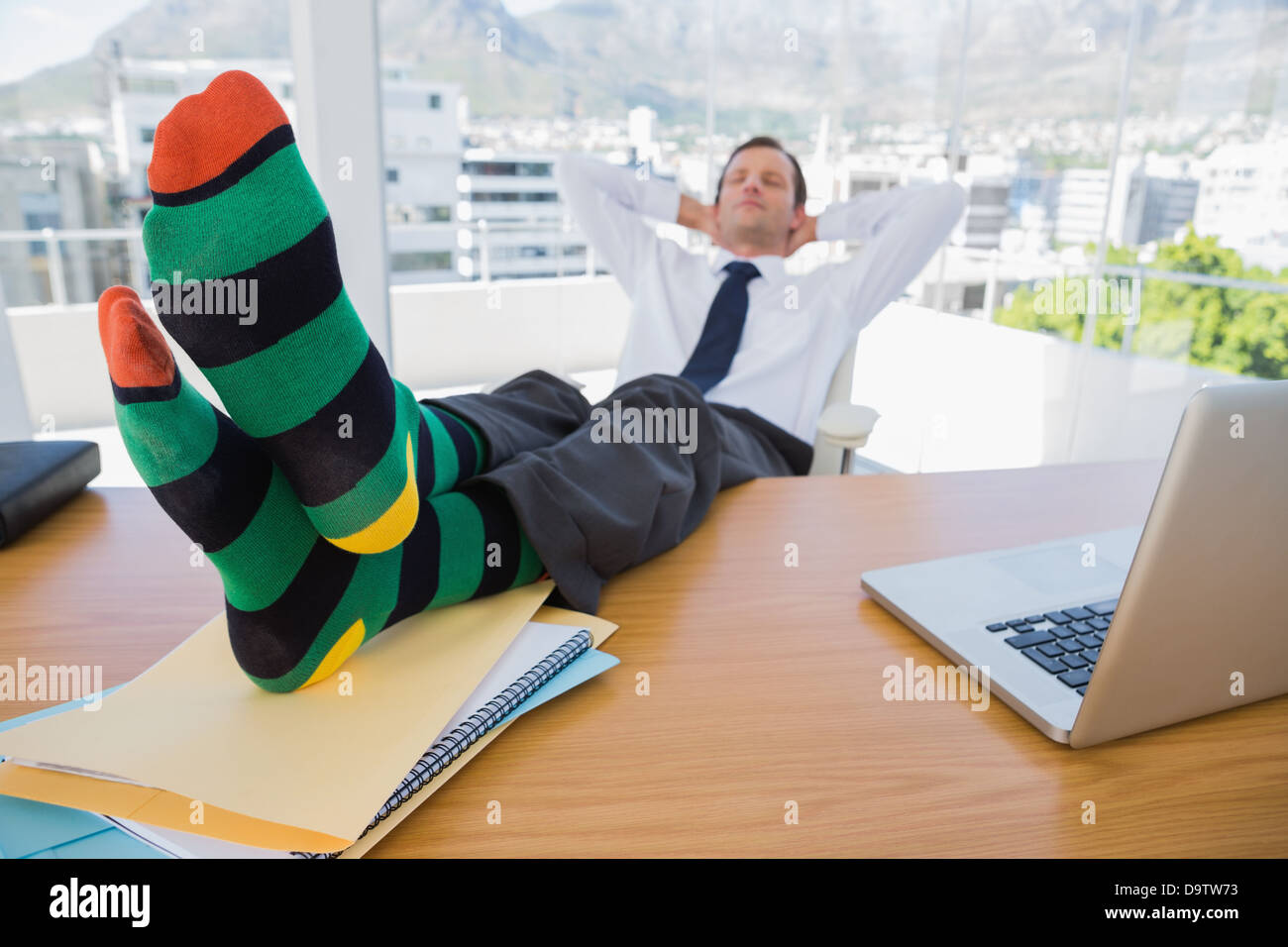 Business having a nap with feet on his desk Stock Photo - Alamy