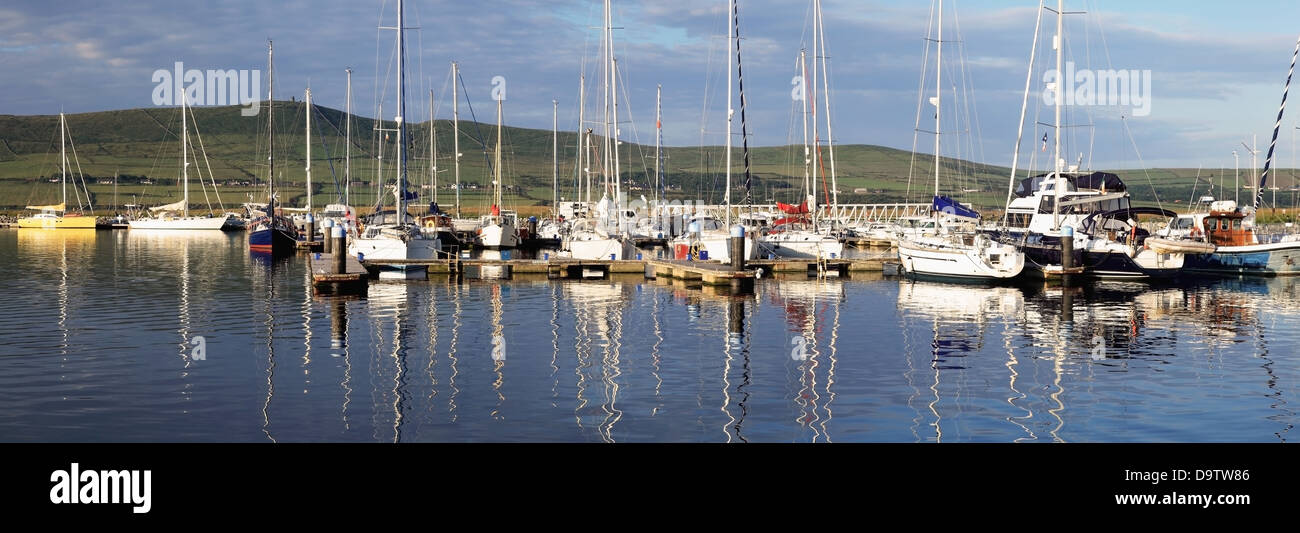 Boats and their reflection in the tranquil water of dingle harbour ...