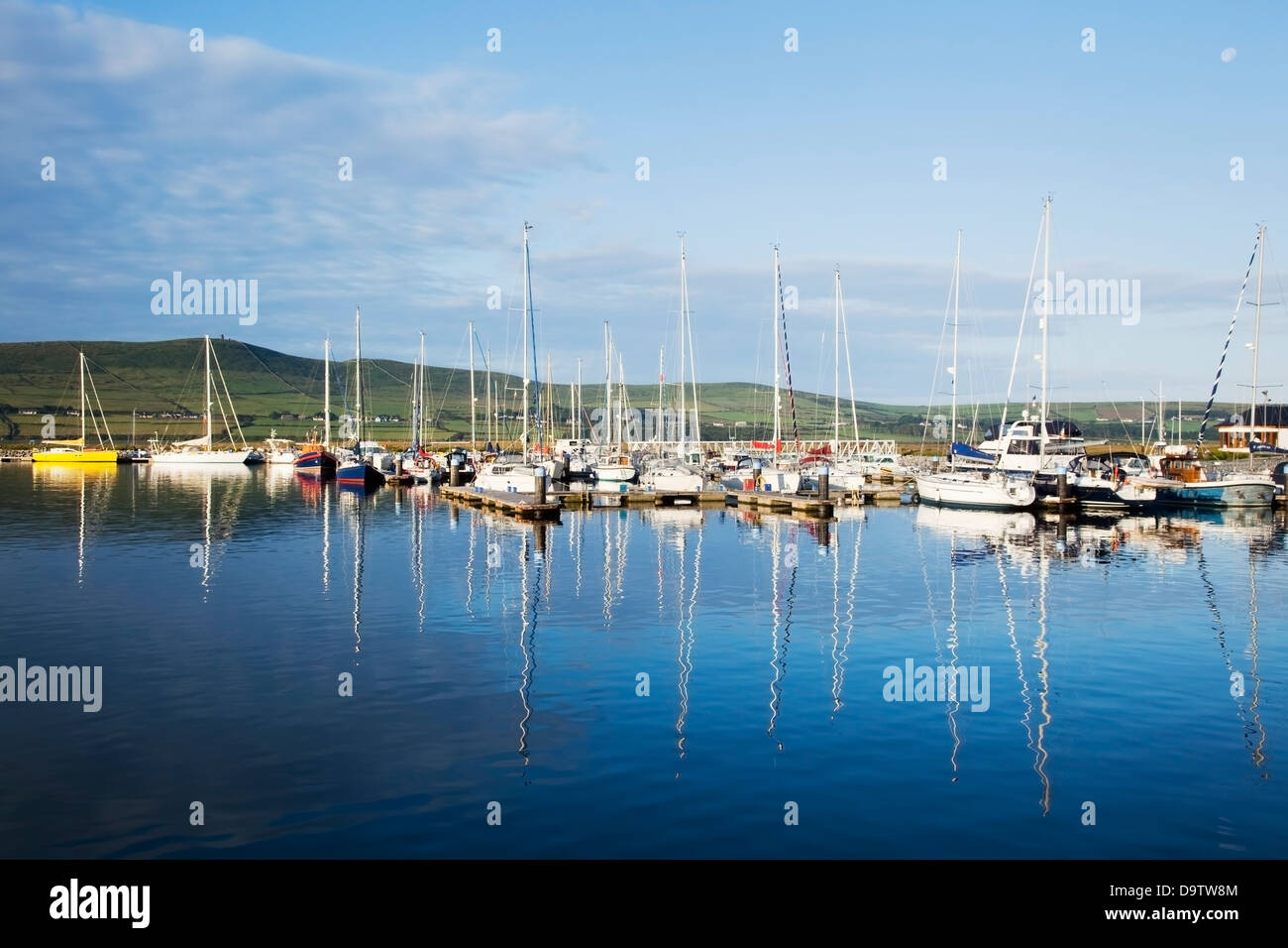 Boats and their reflection in the tranquil water of dingle harbour ...