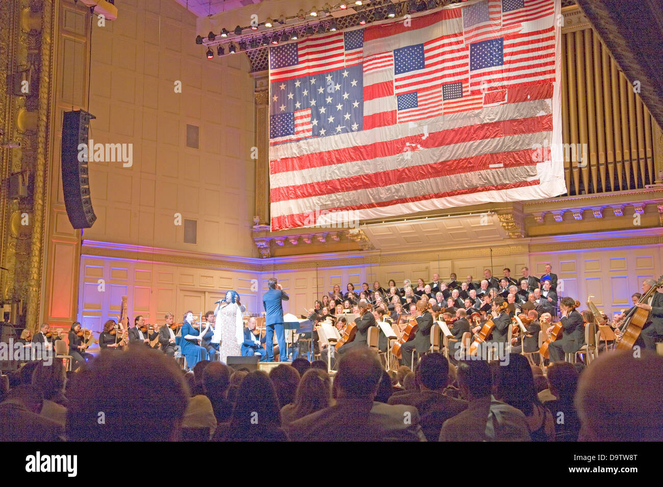 9/11 flag hangs over Keith Lockhart as he conducts the Boston Pops at ...