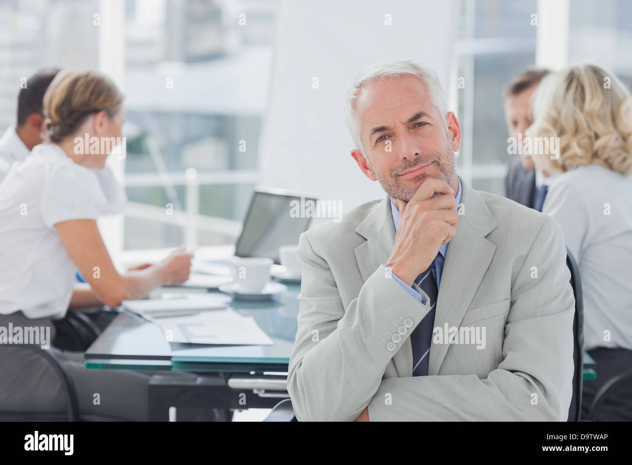 Smiling businessman posing in the boardroom Stock Photo - Alamy