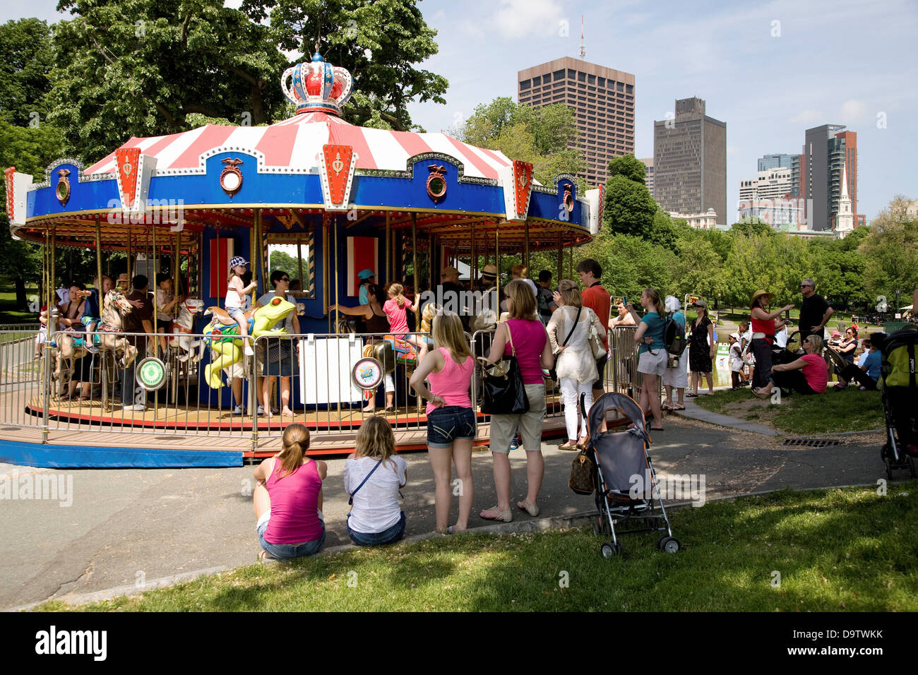 Parents watch children ride the Frog Pond Merry-Go-Round in the Boston ...